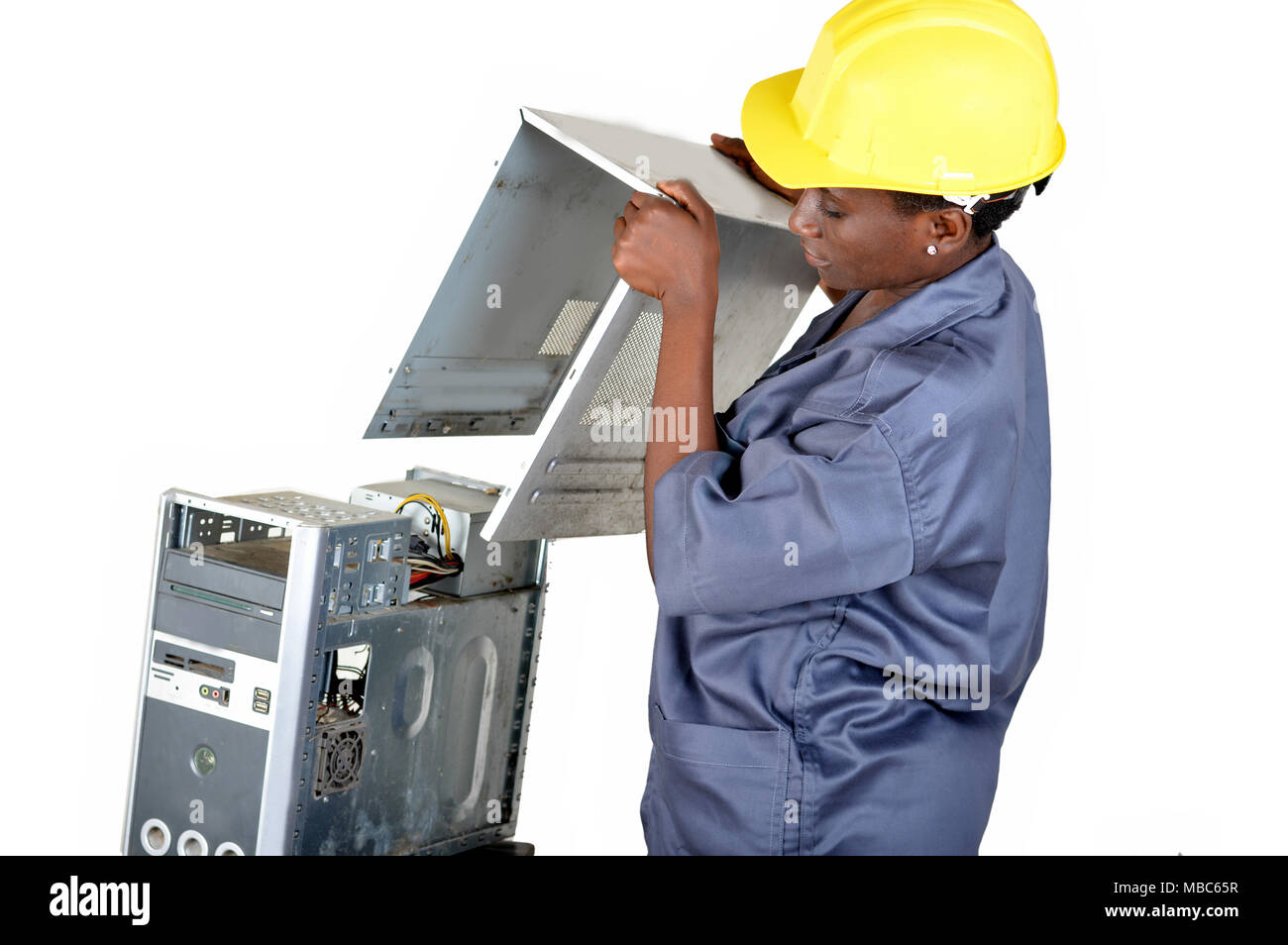 Young computer maintenance technician opens a desktop computer to ...