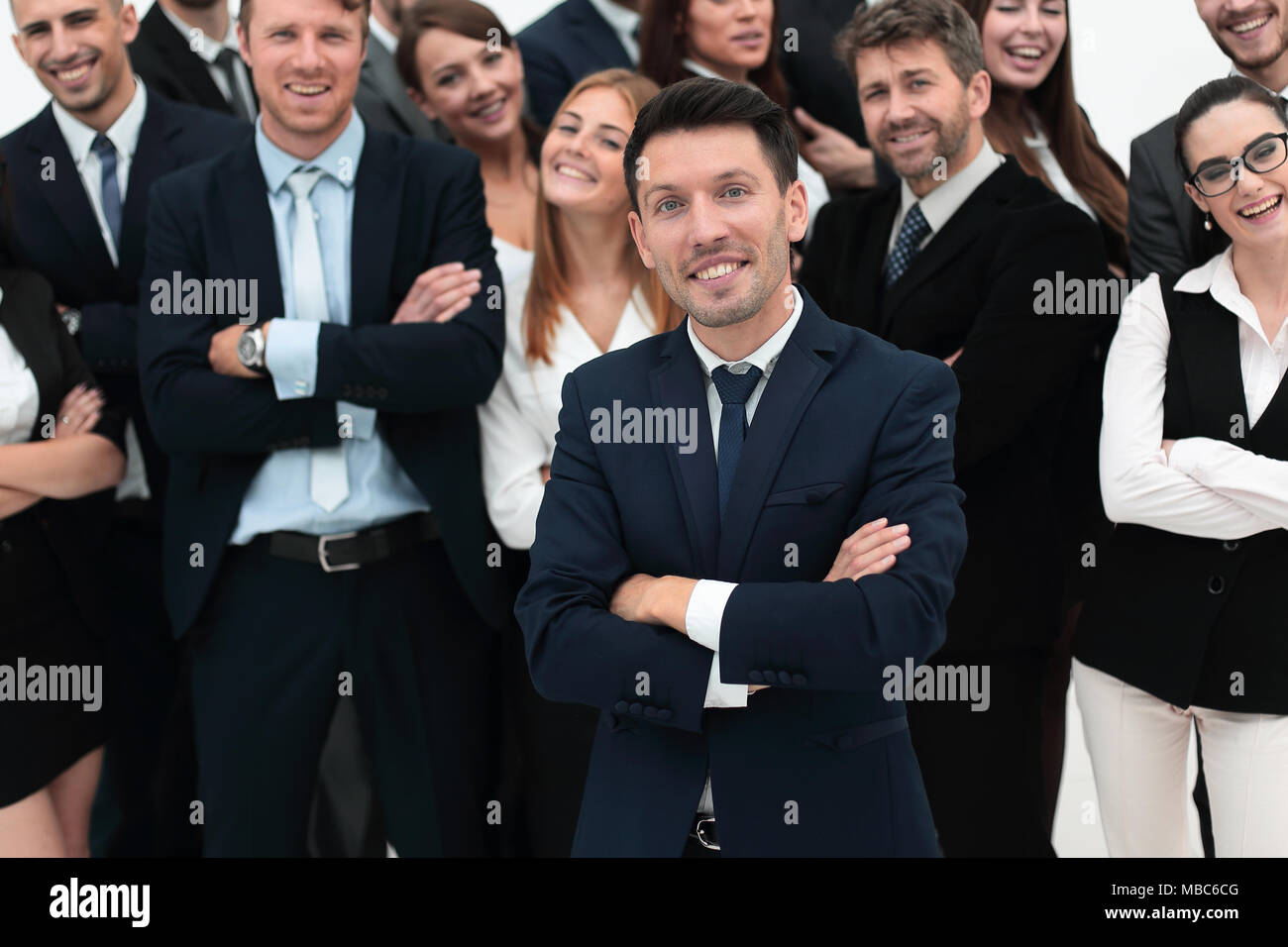 leader standing in front of a large business team Stock Photo - Alamy