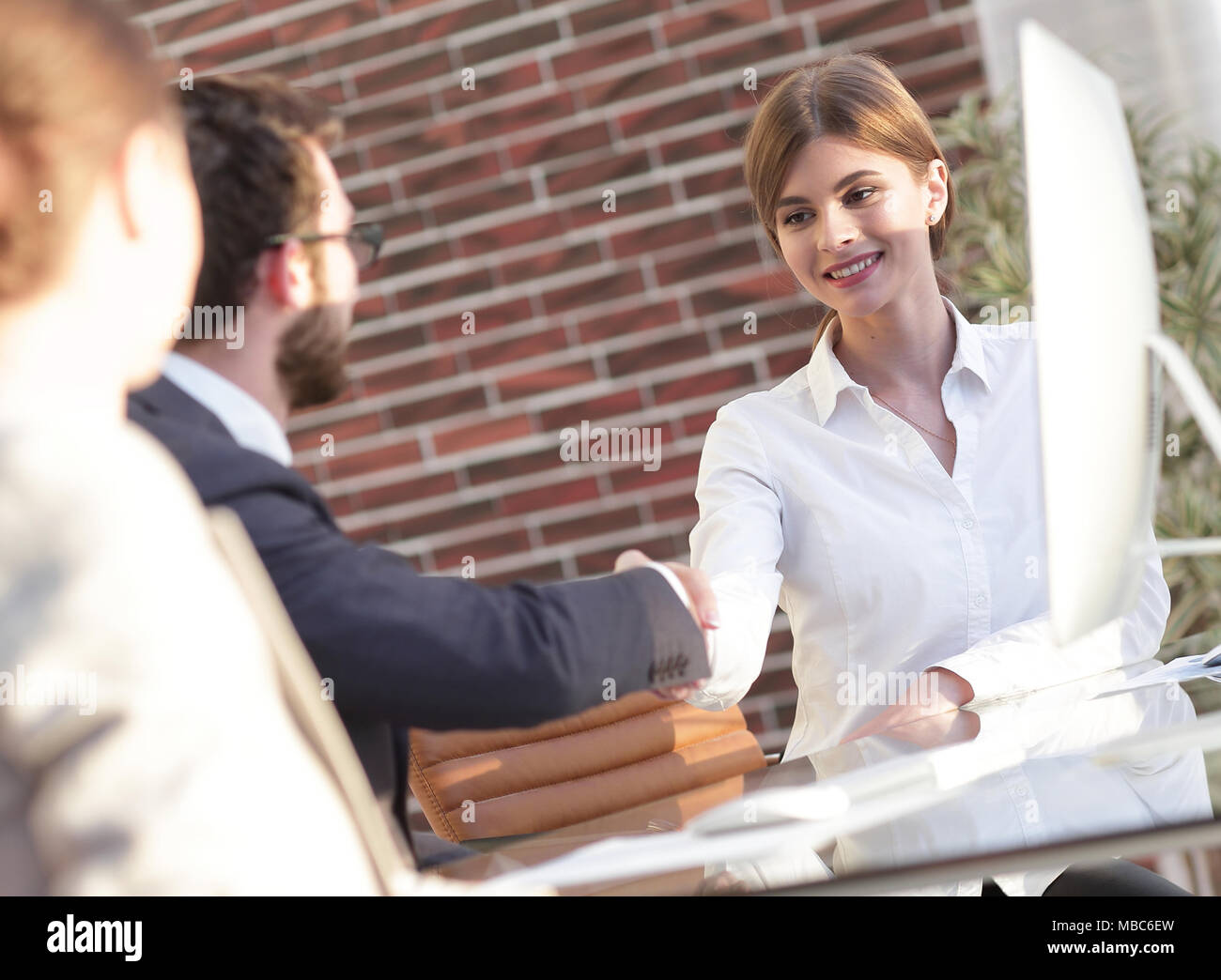 handshake Manager and the client in the office Stock Photo - Alamy