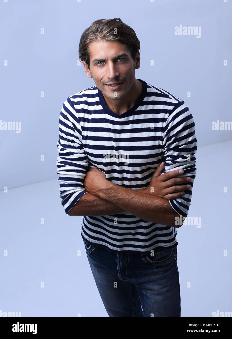 modern man standing in the corner of the white room Stock Photo - Alamy