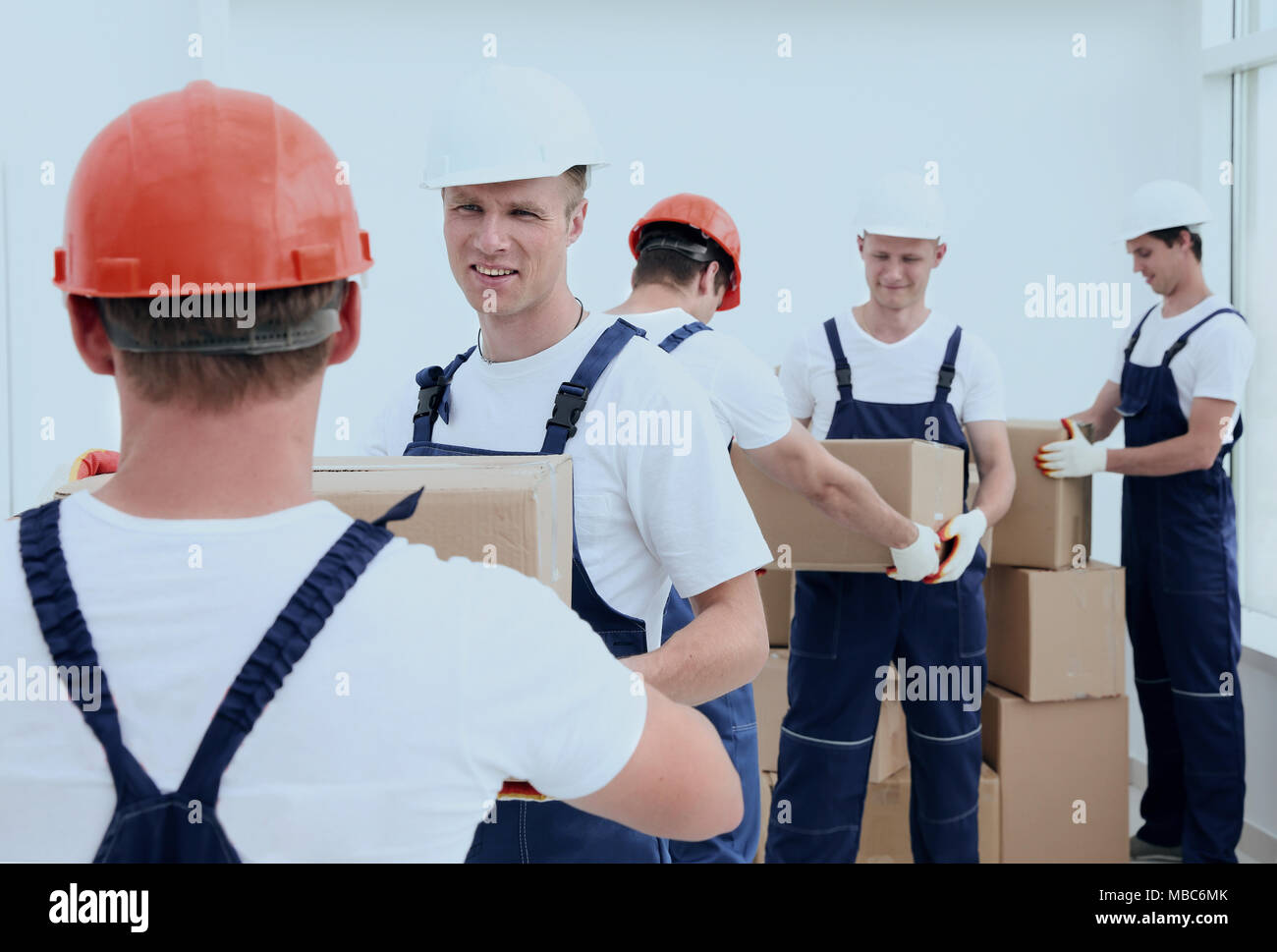 Group of people builders with boxes Stock Photo - Alamy
