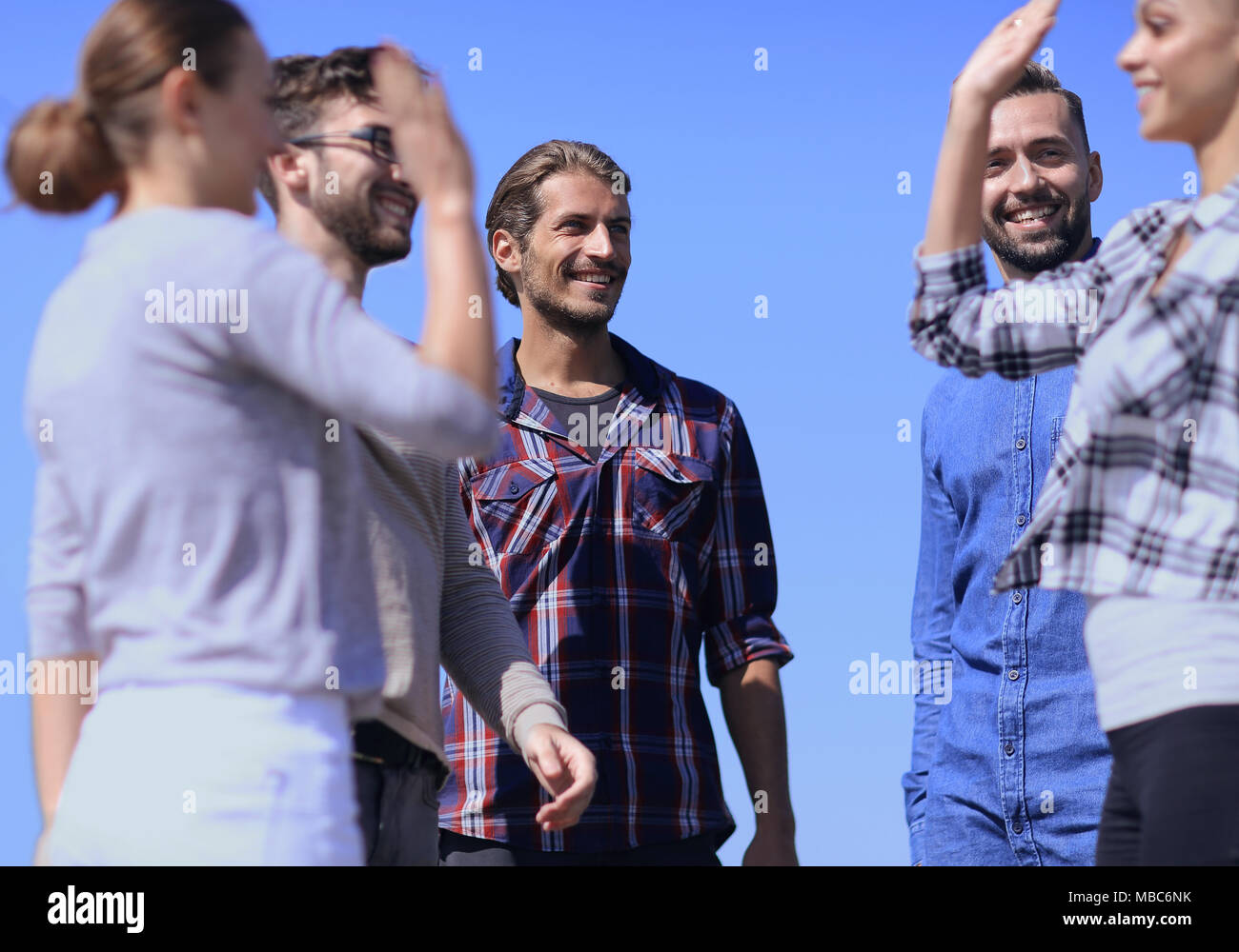 friends students giving each other a high five Stock Photo - Alamy
