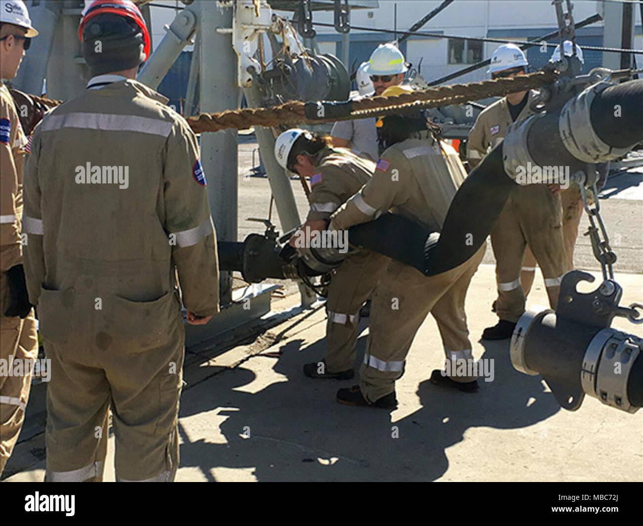 Crew members from the Military Sealift Command chartered ship MT ...