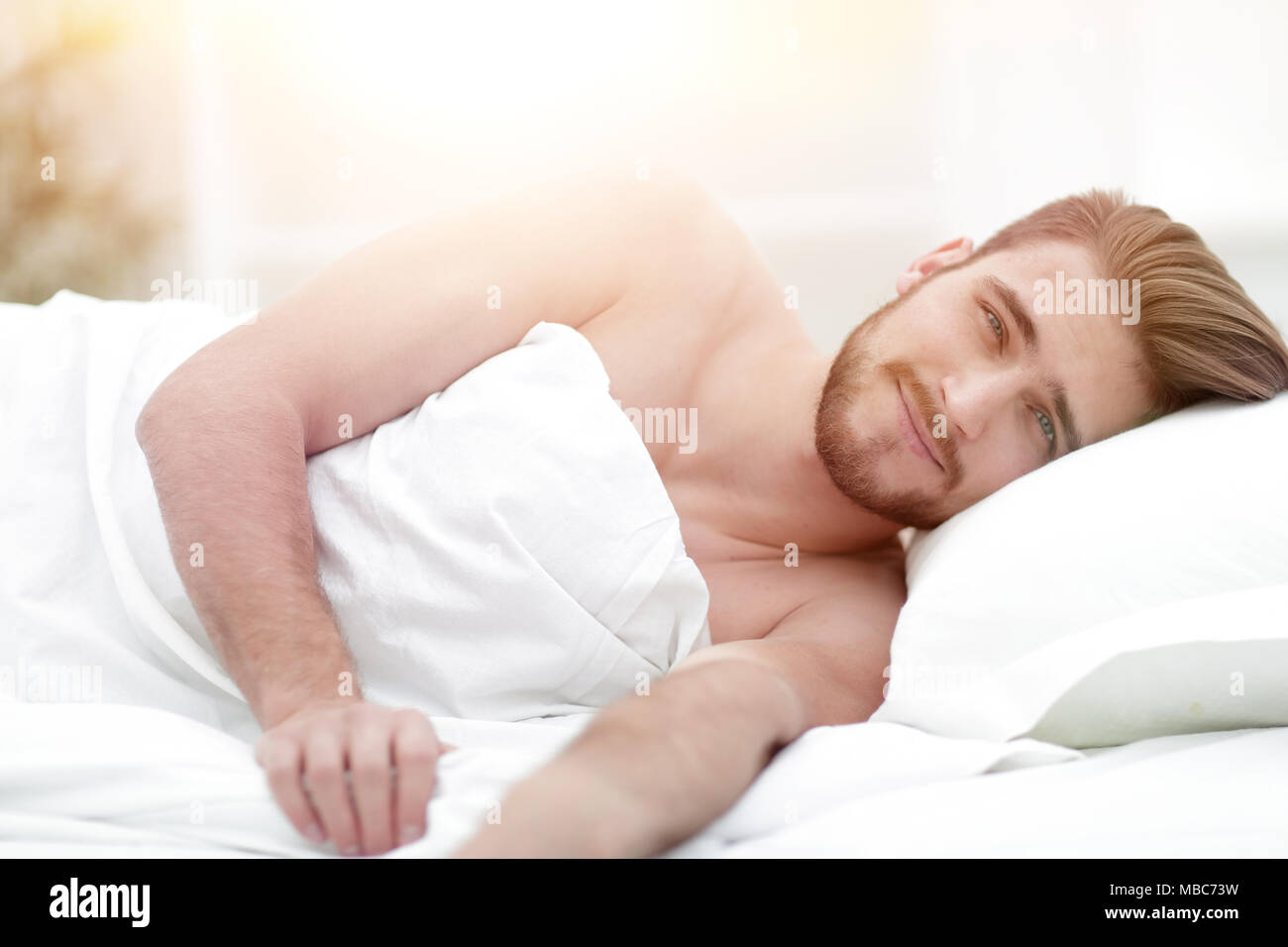 happy man, falling asleep in a comfortable bed Stock Photo - Alamy