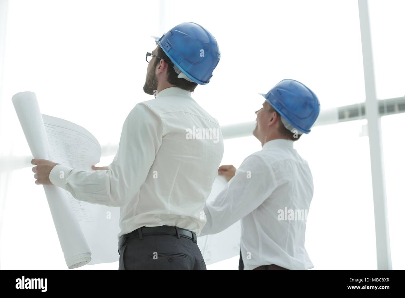 rear view.architect and Builder looking at blank screen Stock Photo - Alamy