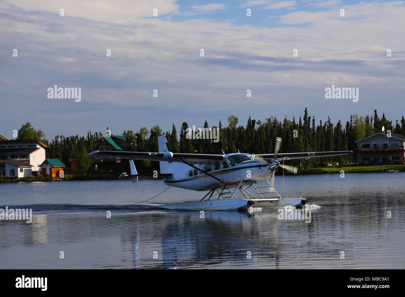 Small Alaska airplane float propeller t plane in a lake Stock Photo - Alamy