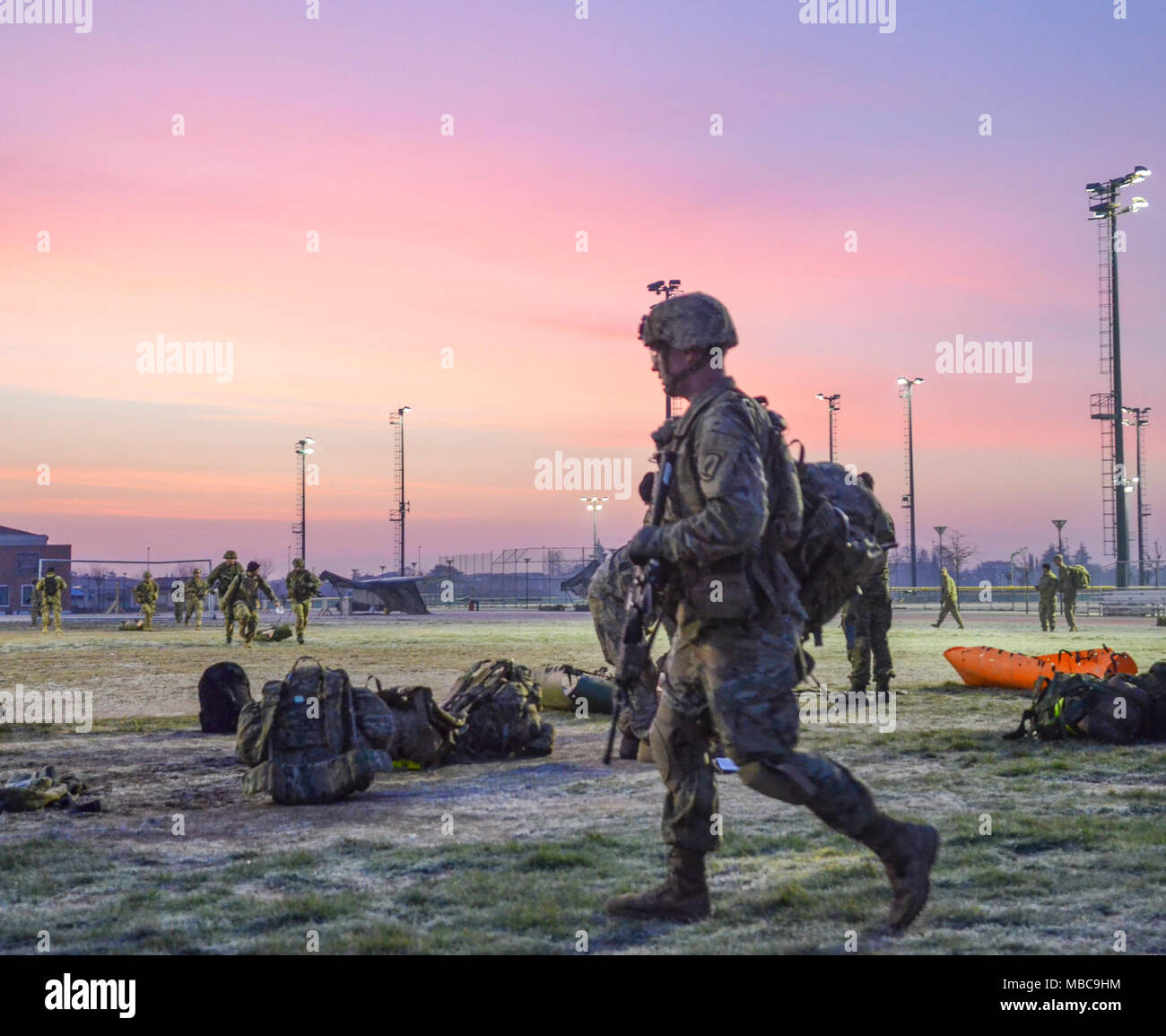 As the morning sun lights the sky, a paratrooper from the 173rd ...