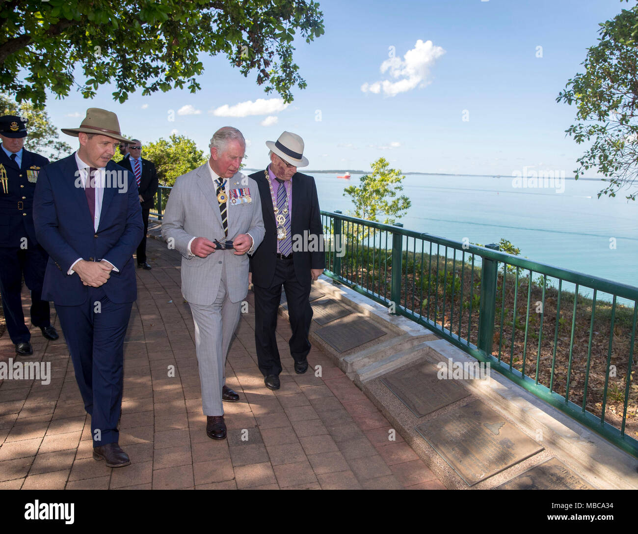 The Prince of Wales is shown memorial plaques at the Cenotaph in Darwin ...