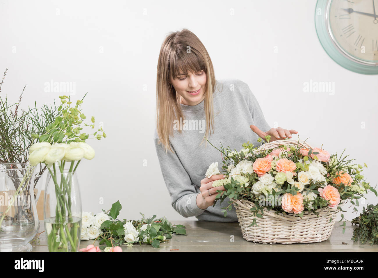 Smiling female florist. Floral workshop - woman making a beautiful ...