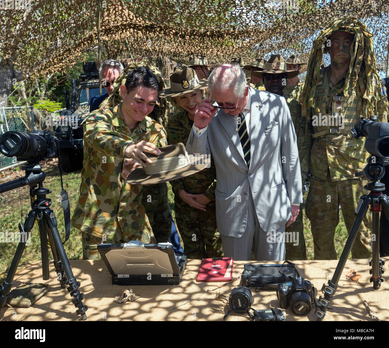The Prince of Wales looks a photo of himself as he meets members of the ...