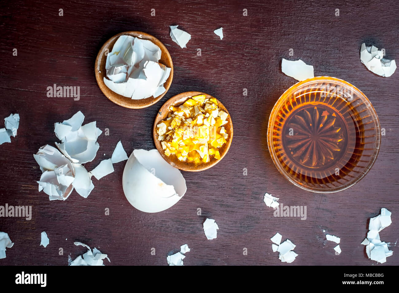 Close up of face pack consisting of egg peel and honey on a wooden ...