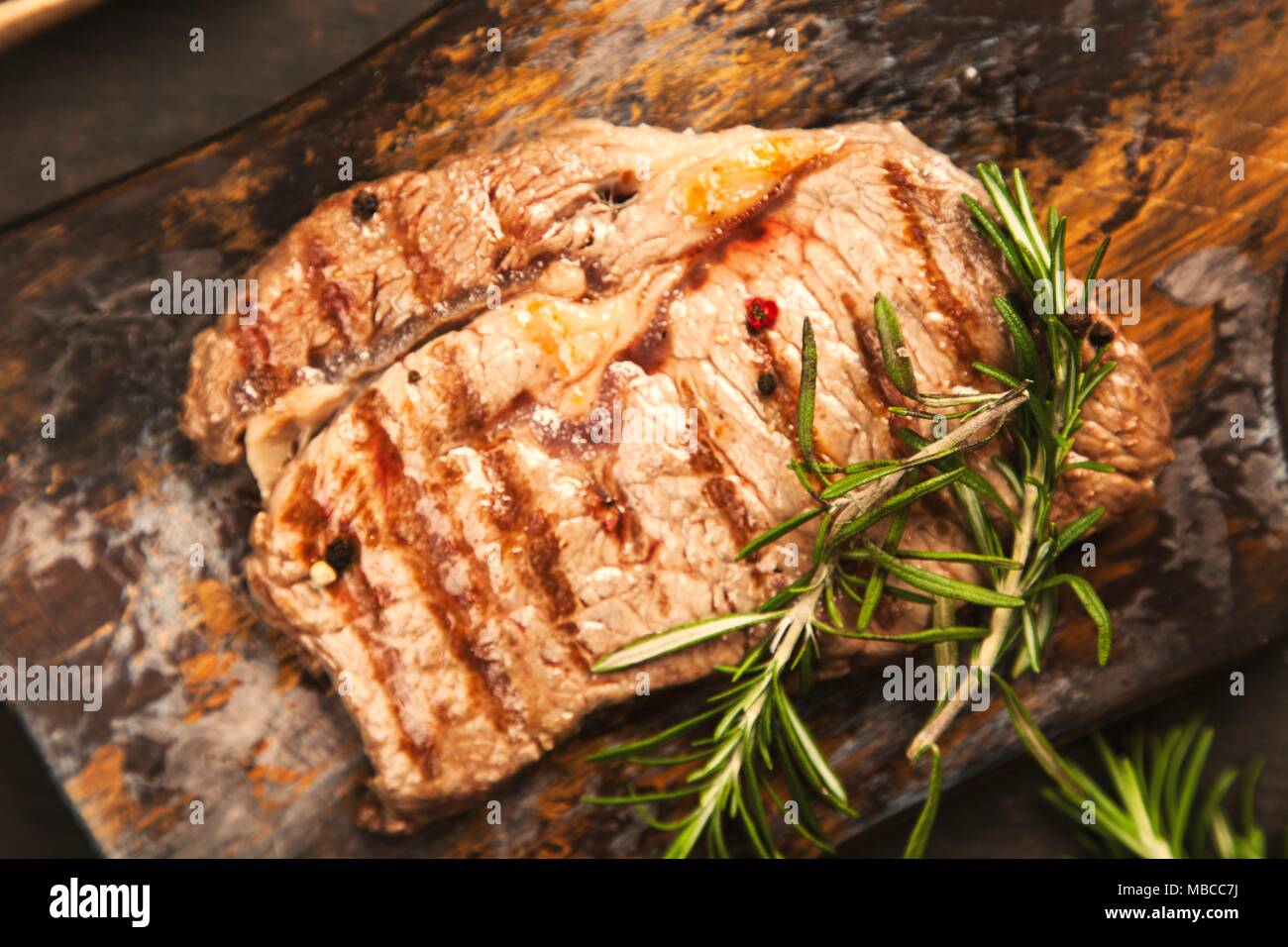 Grilled steak on wooden cutting board Stock Photo - Alamy
