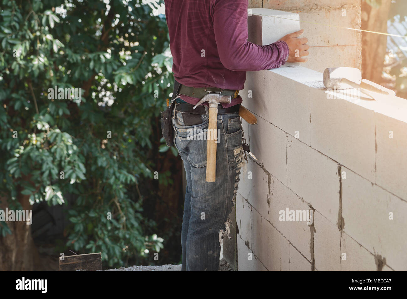 Mason worker building exterior walls, Industrial bricklayer installing ...