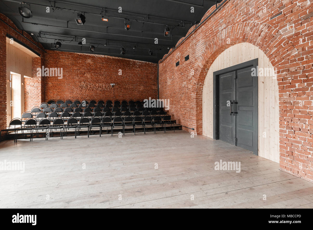 Loft style. Hall with black chairs for webinars and conferences. A huge ...