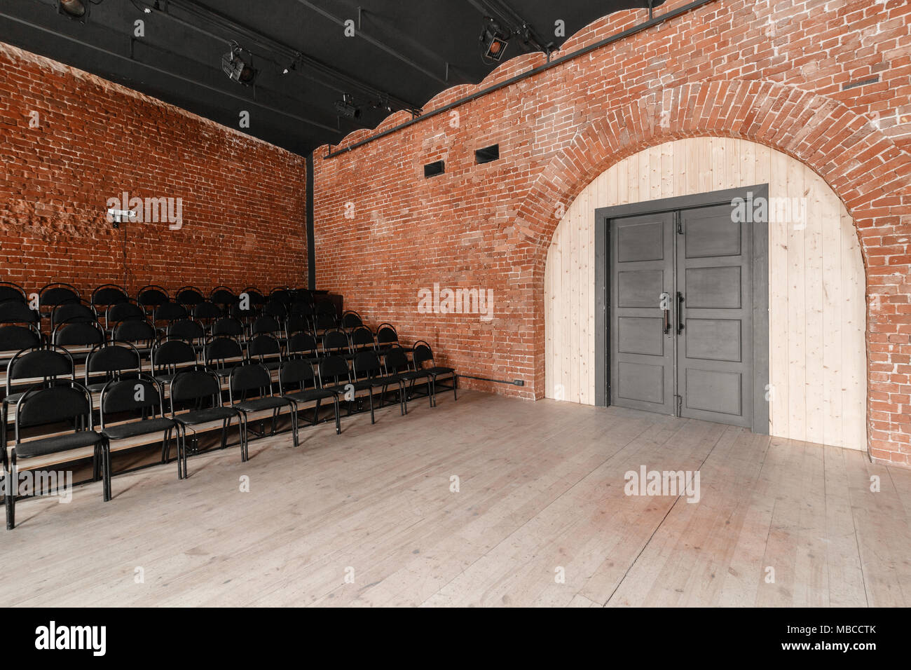 large door. Loft style. Hall with black chairs for webinars and ...