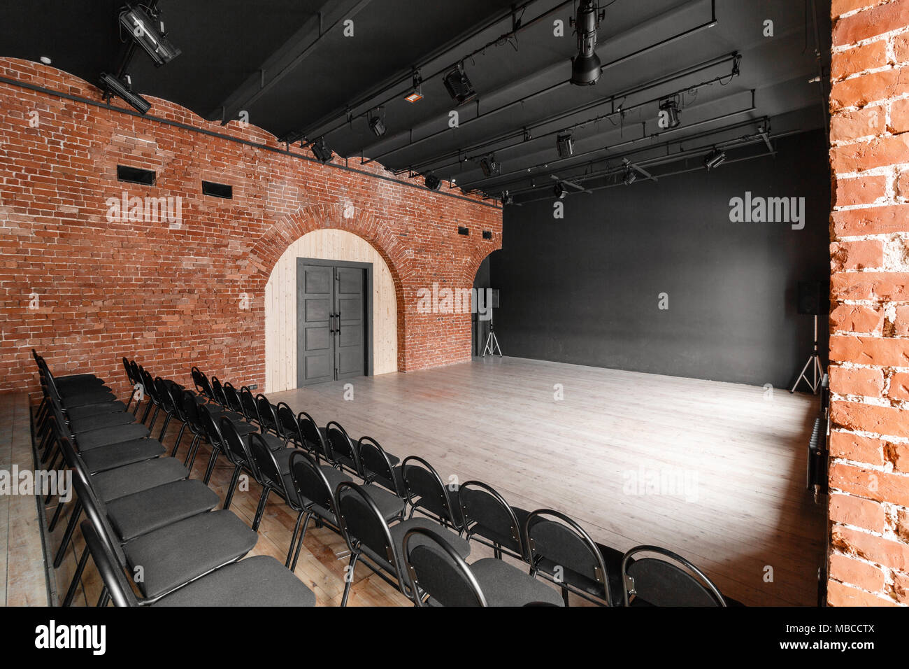 Loft style. Hall with black chairs for webinars and conferences. A huge ...
