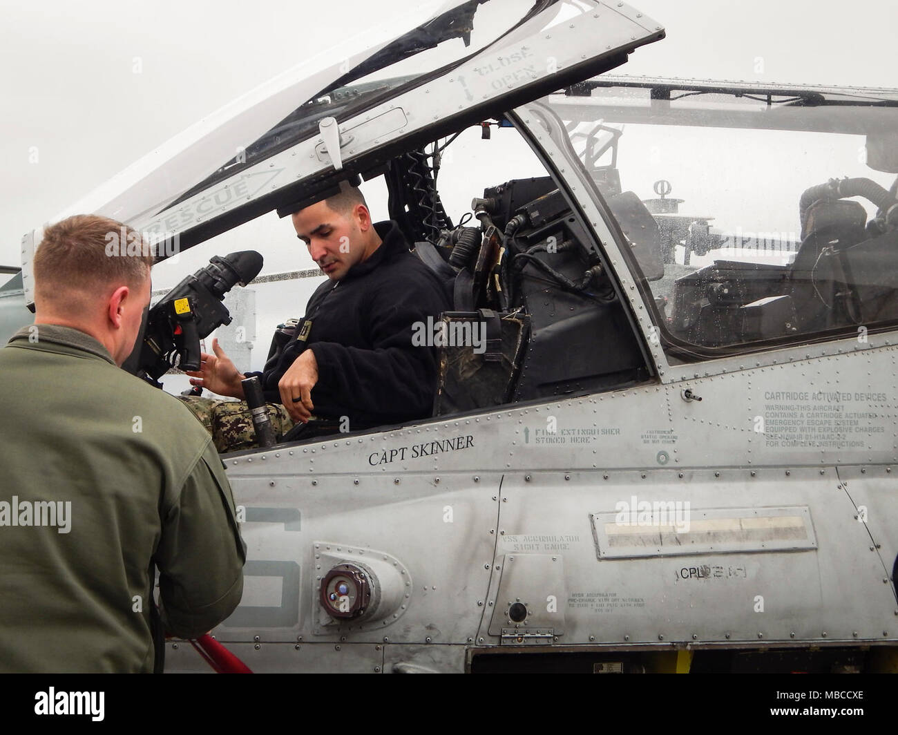 Lt. Mike Pires, seated, a Surface Warfare Officer and Warfare Tactics ...