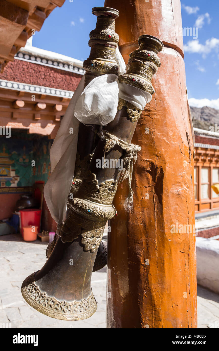 Two brass horns tied to supporting wood column at Rizong Monastery are ...