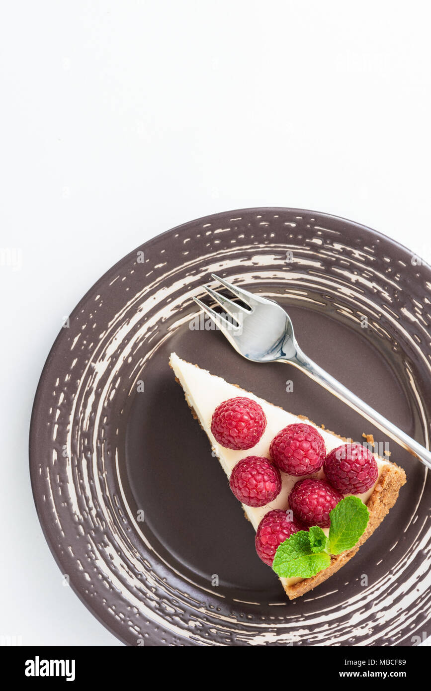 Slice of cheesecake with raspberries on plate. Isolated on white ...