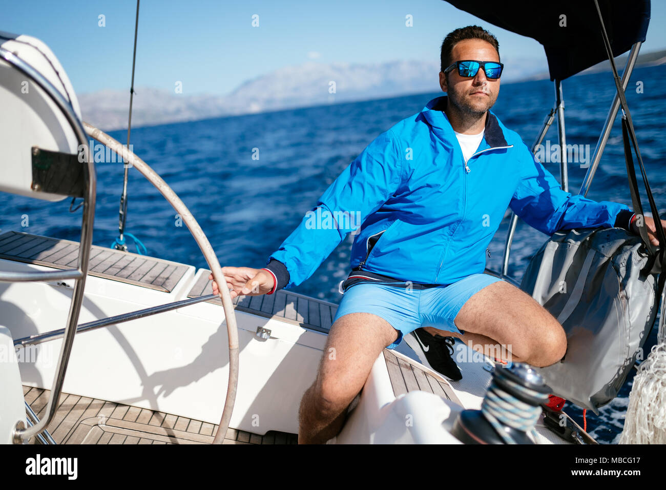 Handsome strong man sailing with his boat Stock Photo - Alamy