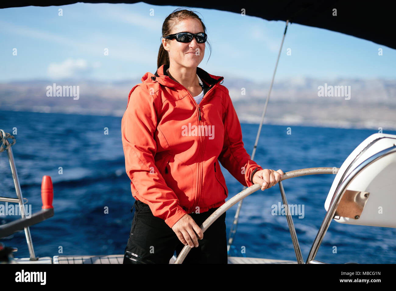 Attractive strong woman sailing with her boat Stock Photo - Alamy