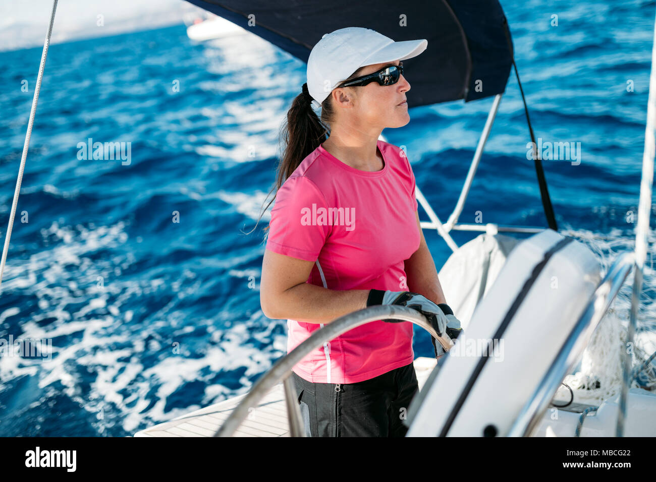 Happy strong woman sailing with her boat Stock Photo - Alamy
