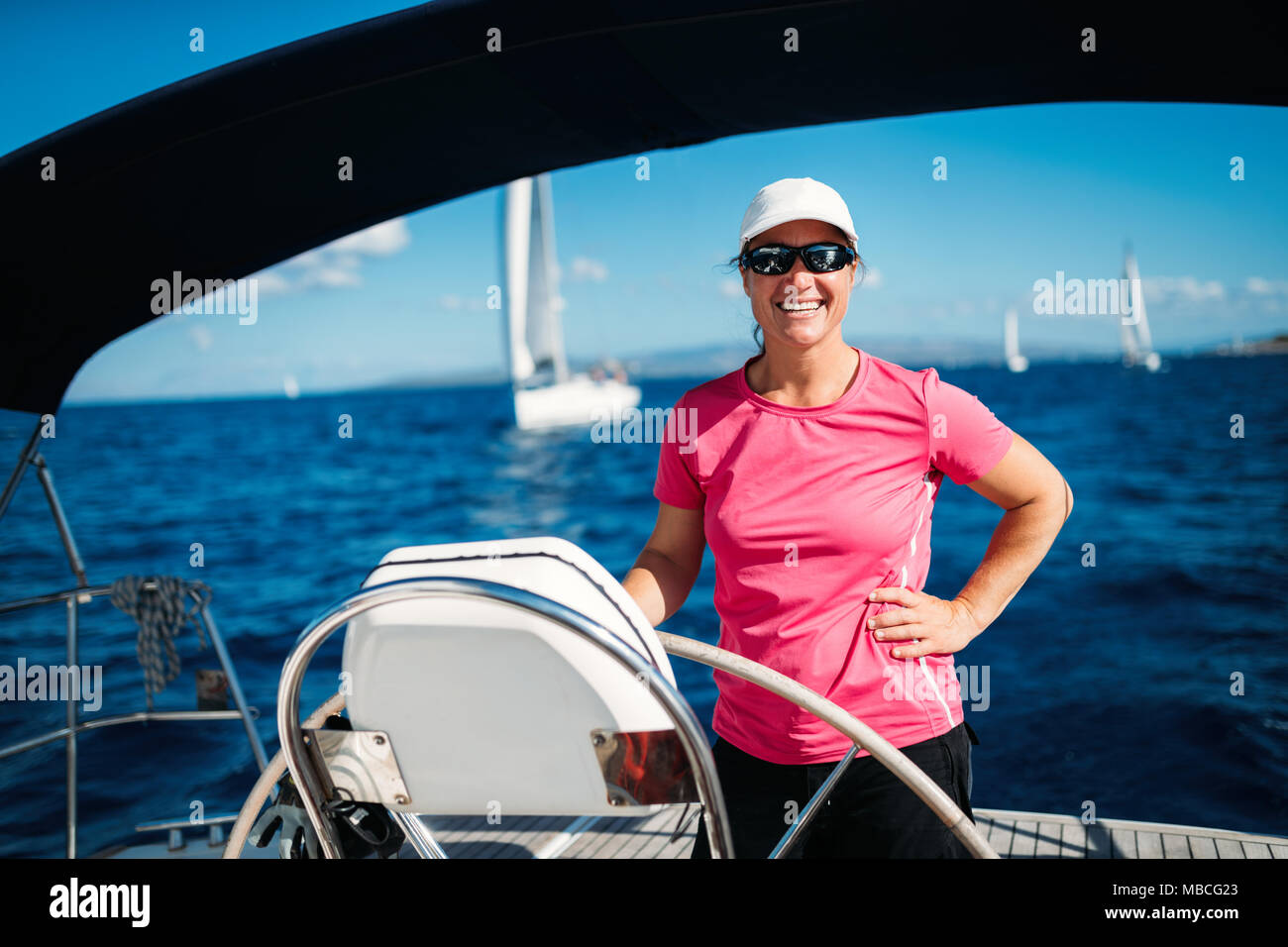 Happy strong woman sailing with her boat Stock Photo - Alamy