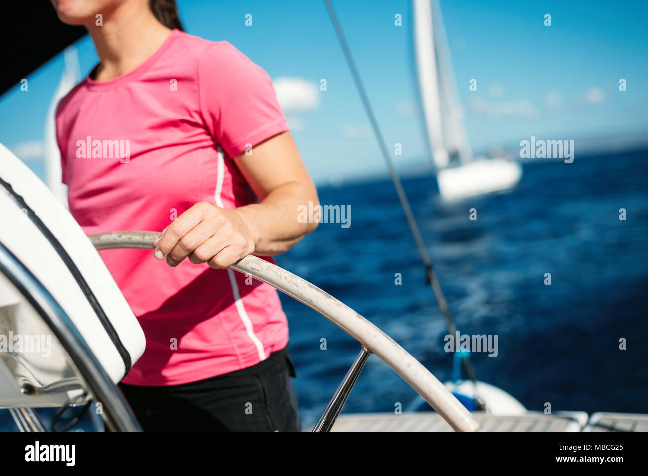 Happy strong woman sailing with her boat Stock Photo - Alamy