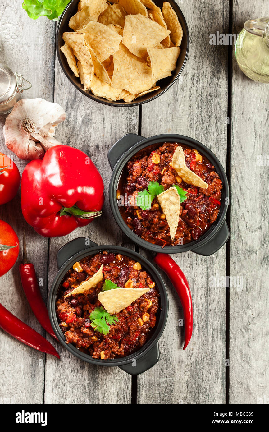 Bowls of hot chili con carne with ground beef, beans, tomatoes and corn ...