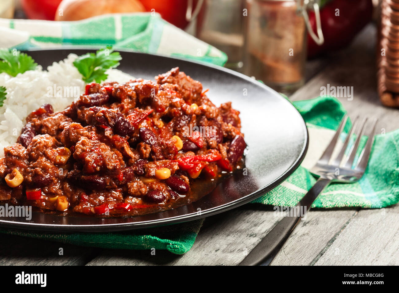 Hot chili con carne with ground beef, beans, tomatoes and corn served ...