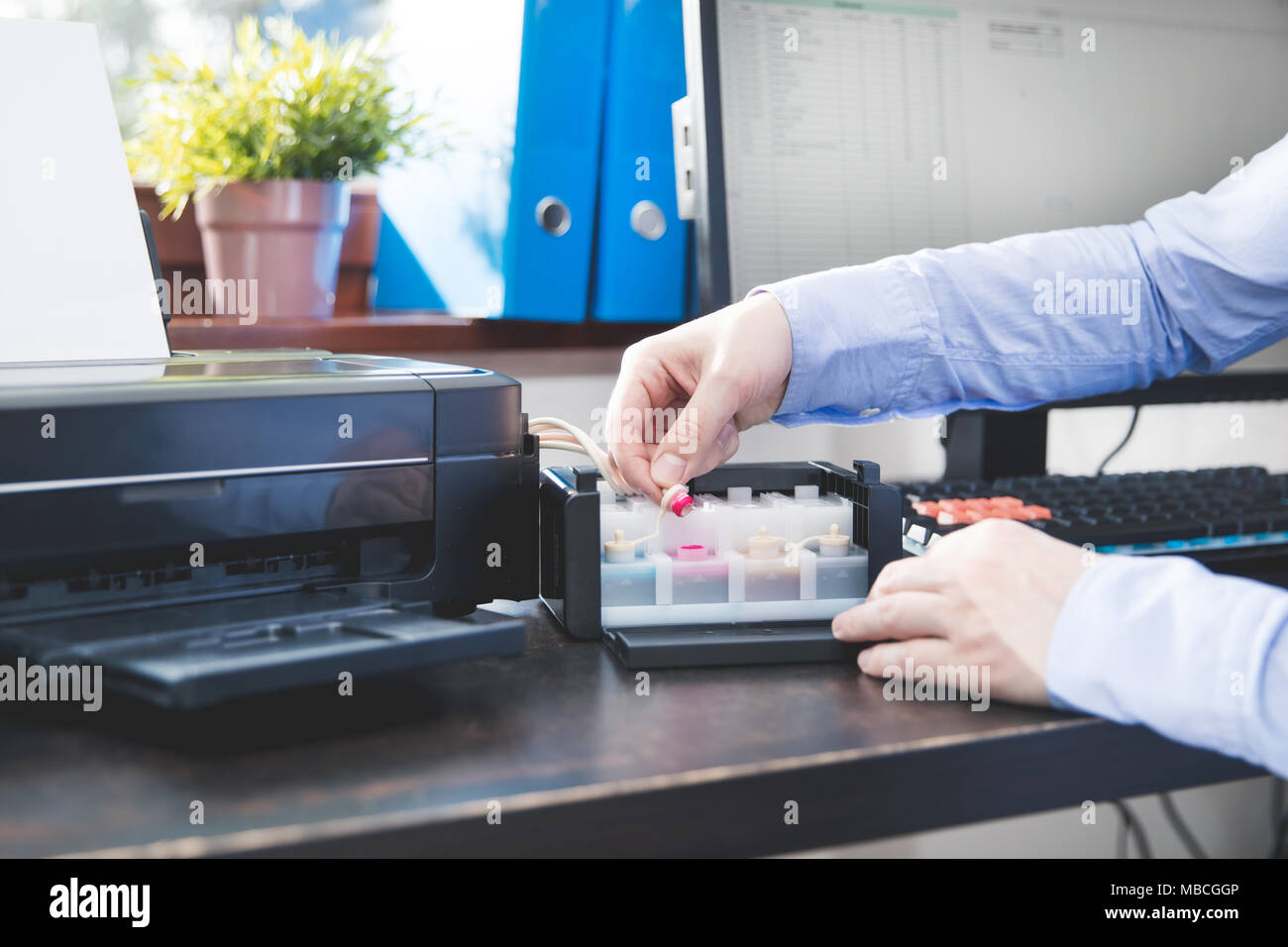 Businessman checks how much ink has been left in the printer's ...