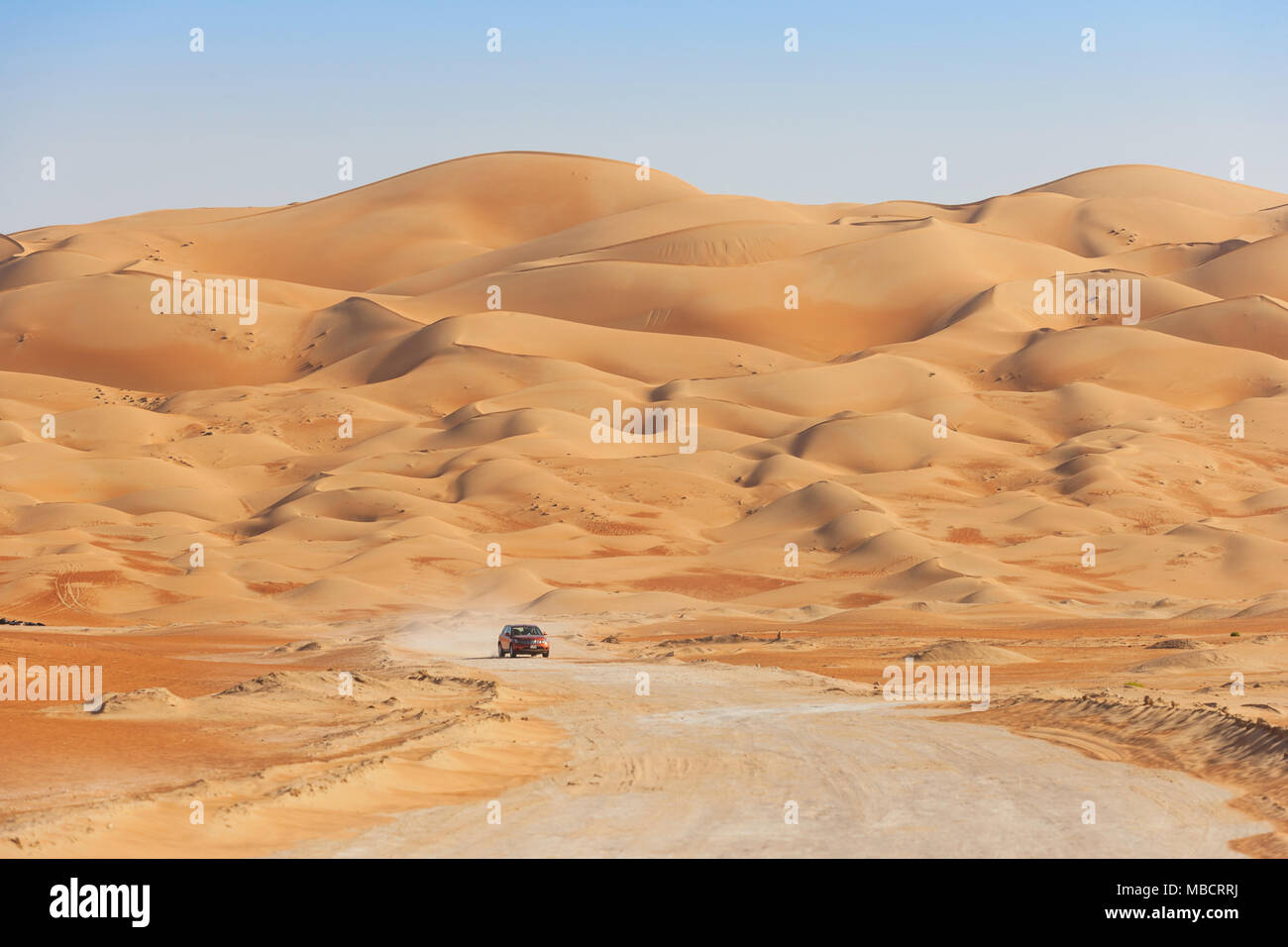 A vehicle driving through sand dunes in the Rub al Khali or Empty ...