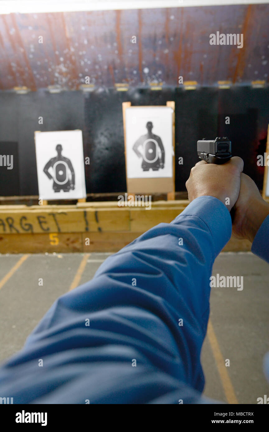 Man, possibly a police officer, doing target practice at a shooting ...