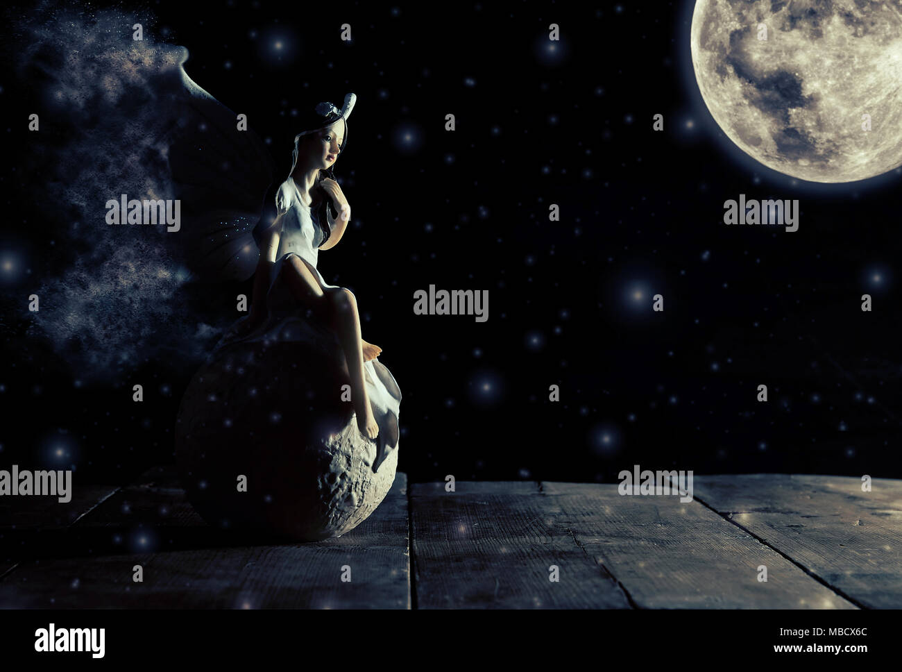 image of magical little fairy sitting over the stone at moonlight Stock ...