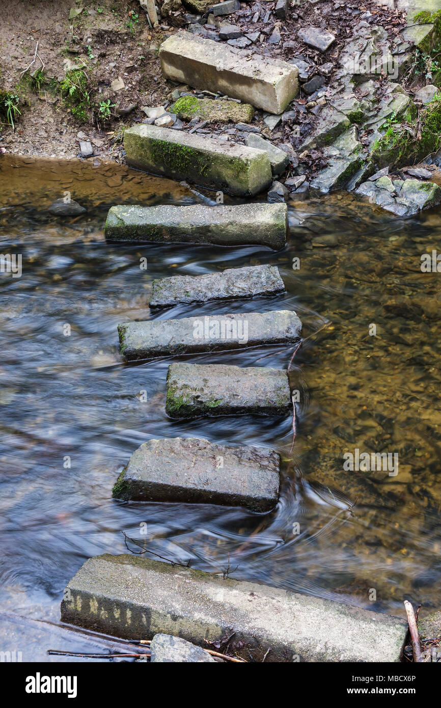 stone bridge across clean water flow Stock Photo - Alamy