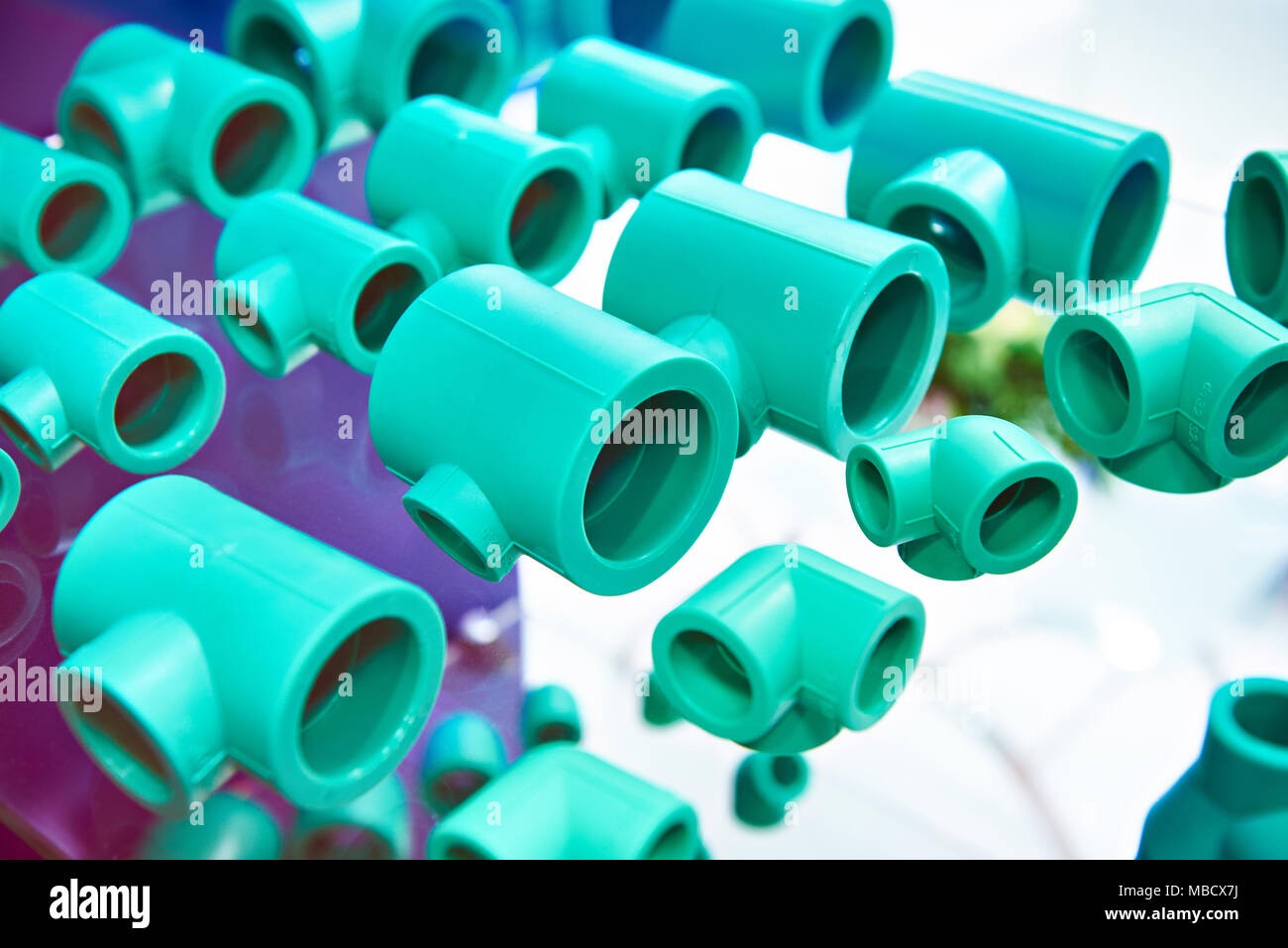 Green plastic fittings for the plumbing system in shop Stock Photo - Alamy