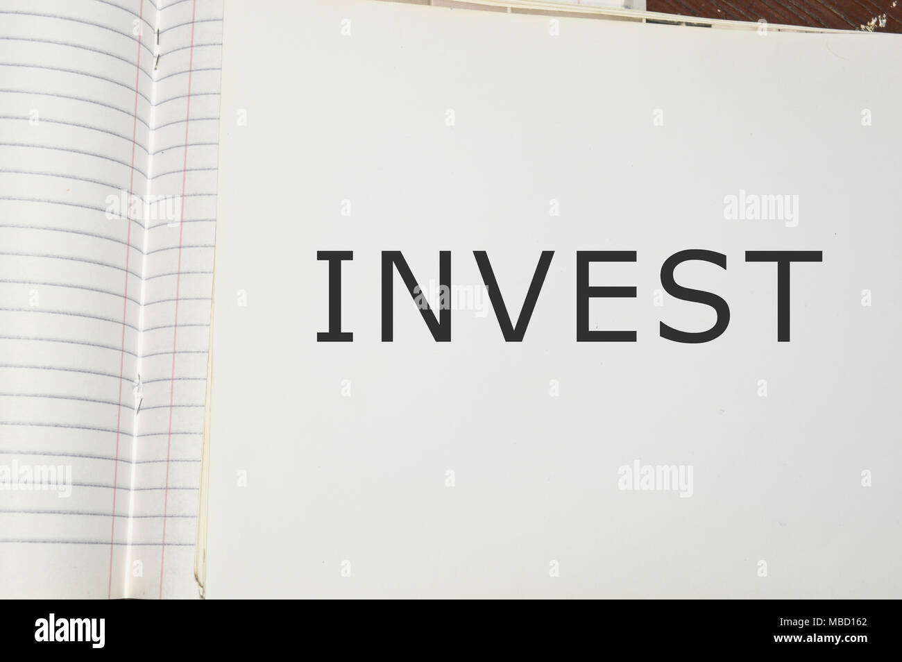 invest word written on white paper Stock Photo - Alamy