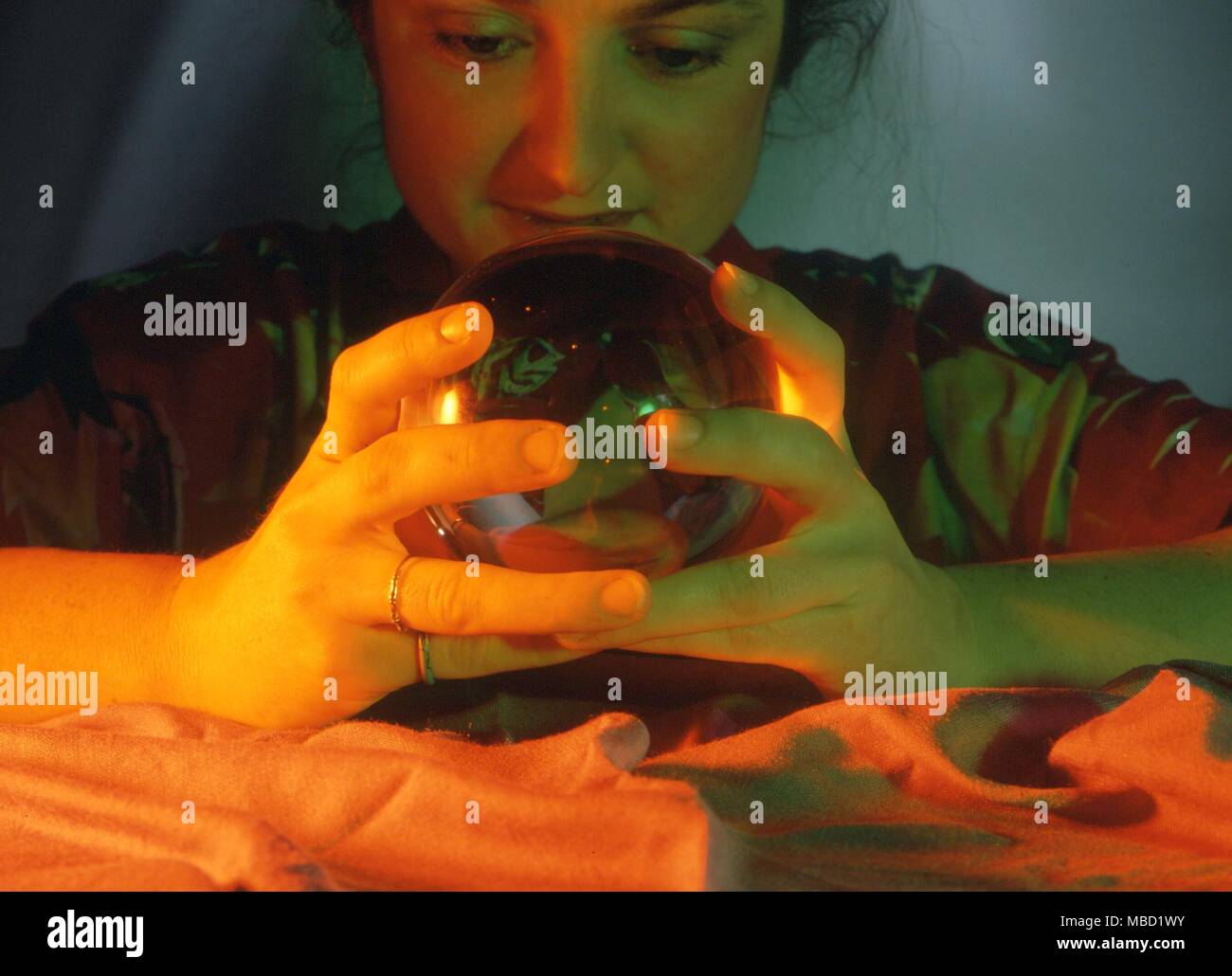 Crystal gazing A medium practicing the art of scrying by gazing into a ...