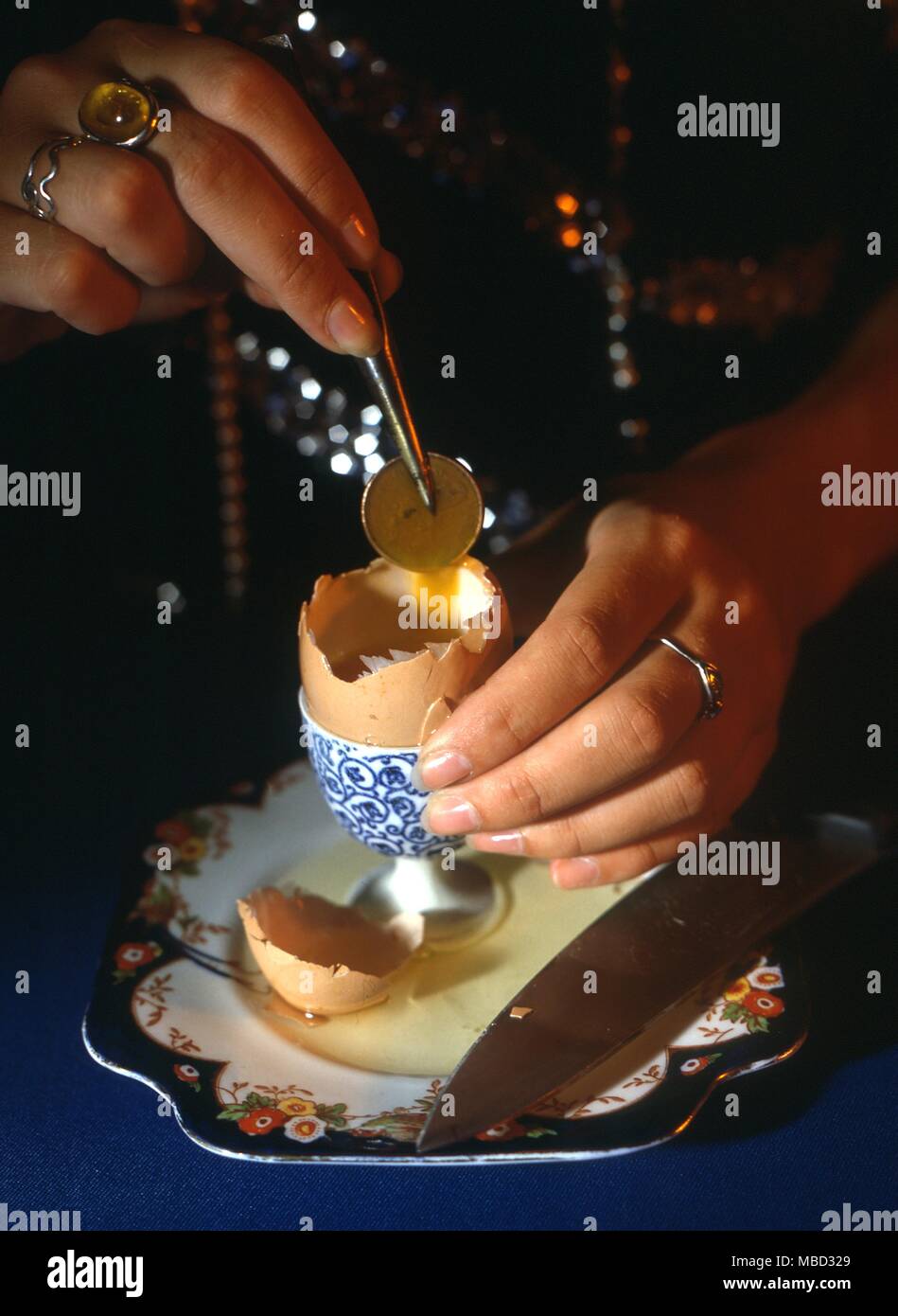 Stage Magic - Coin in Egg. The magician puts an egg into an eggcup ...