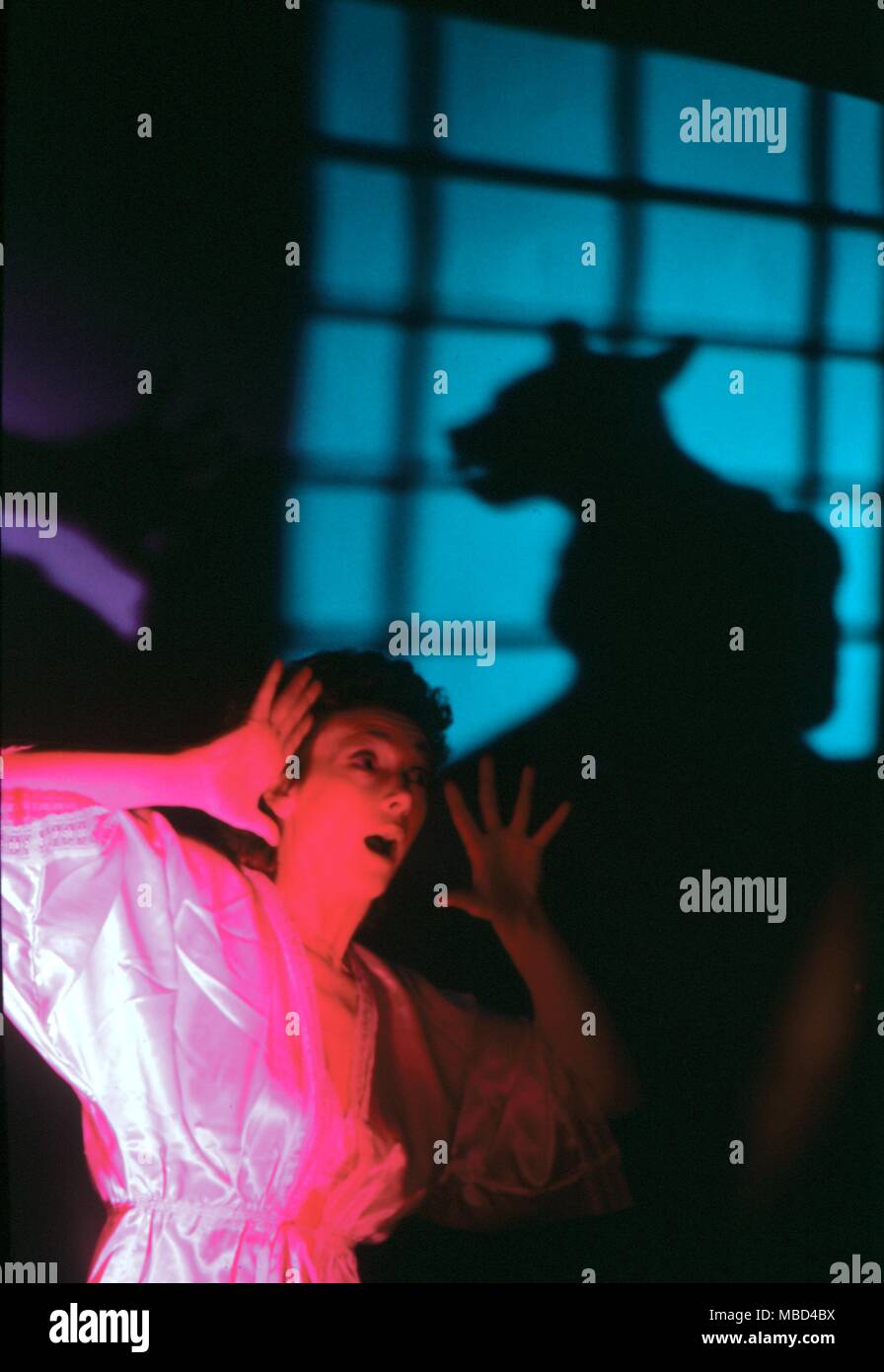 Horror - woman in fear because of monstrous shadow. - © / Charles ...