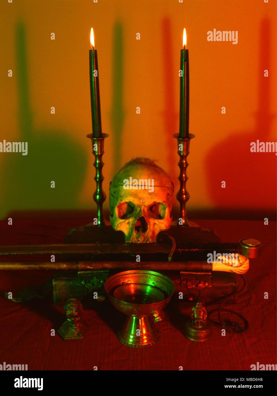 Detail of a ritual altar, with grimoire, skull, candles, ritual rod and ...