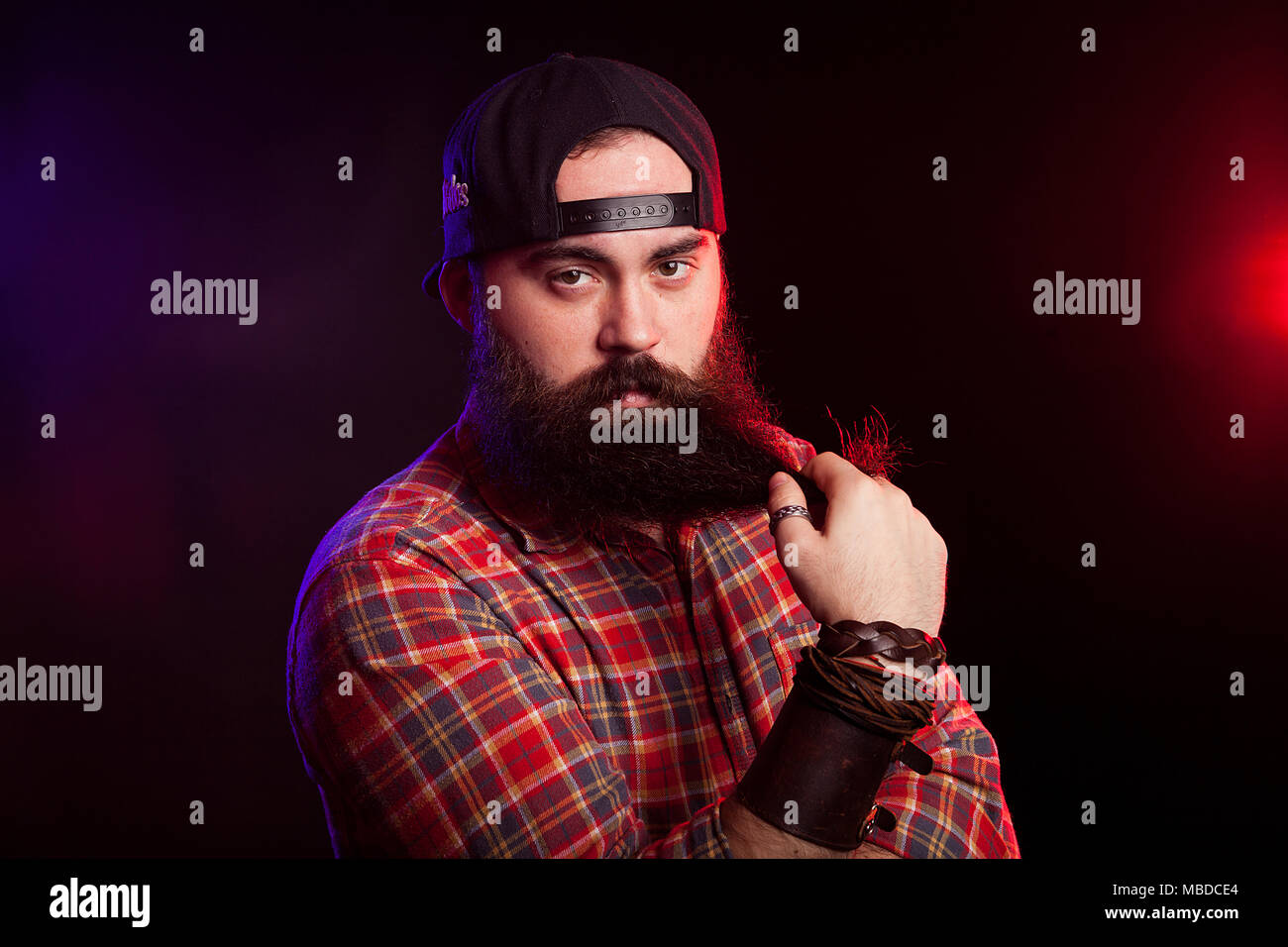 Angry bearded hipster man holding his beard in hands Stock Photo - Alamy