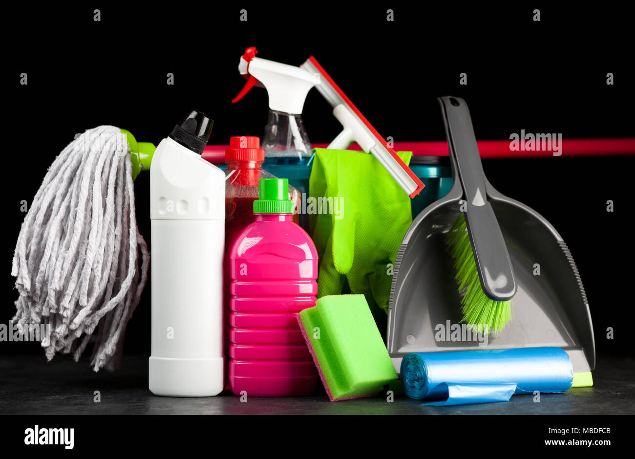 Cleaning supplies on black background Stock Photo - Alamy