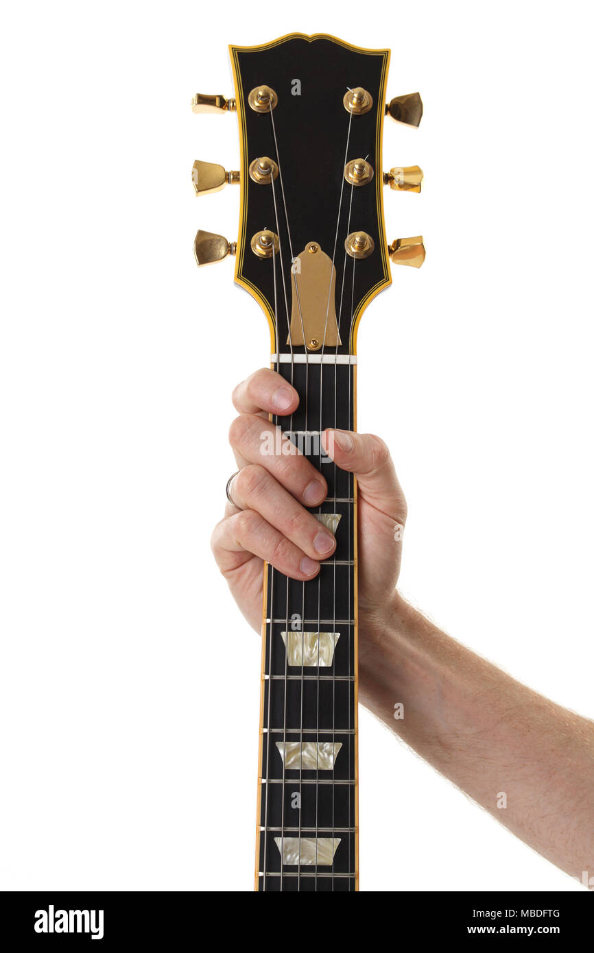 Hand holding a bass guitar neck isolated Stock Photo - Alamy