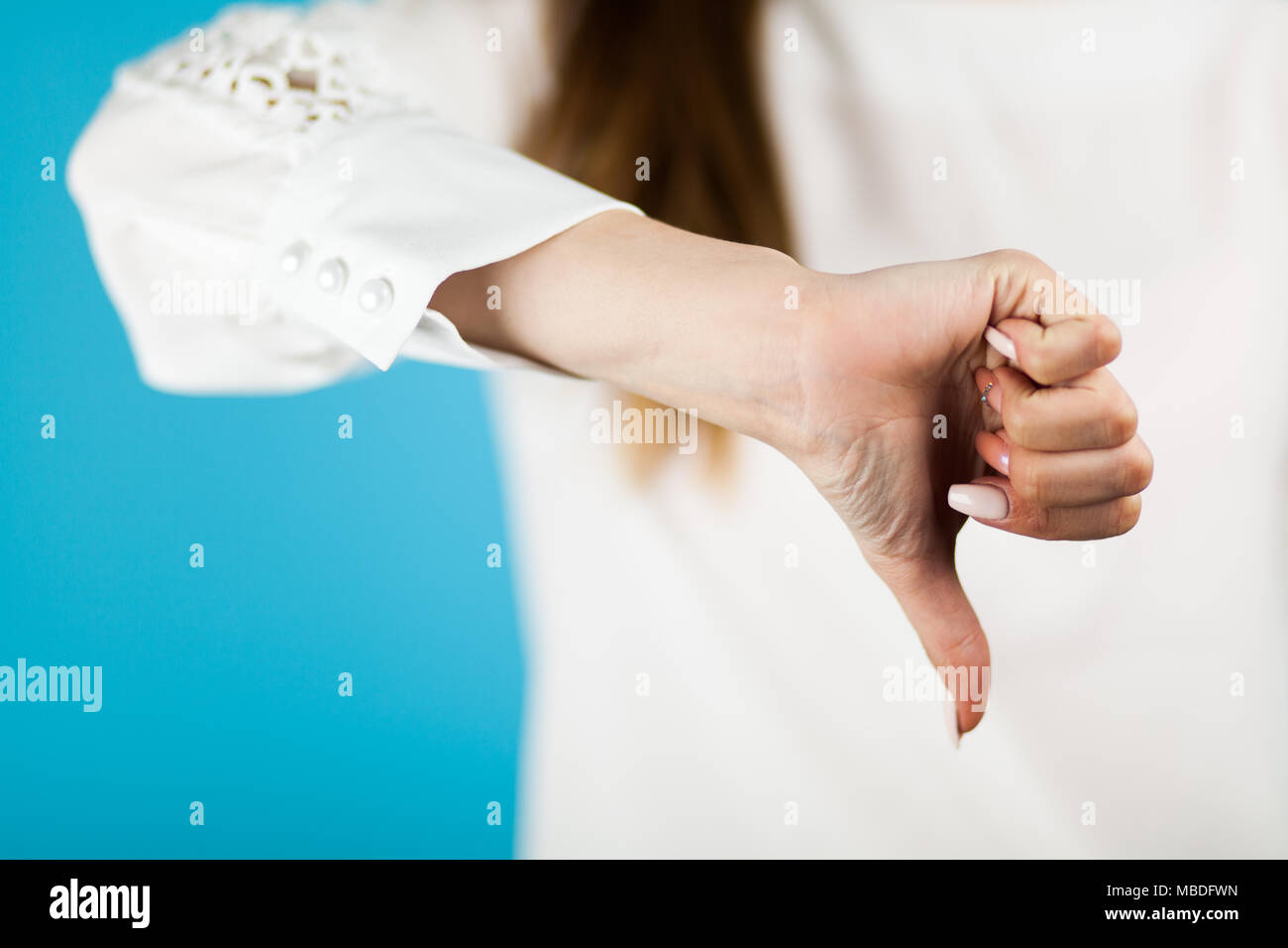 Female hand on blue background Stock Photo - Alamy