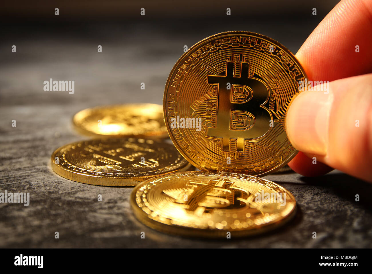 Man holding Golden Bitcoin over black background. Business concept ...