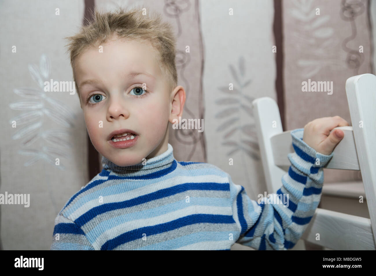 boy with disheveled hair standing in a room Stock Photo - Alamy