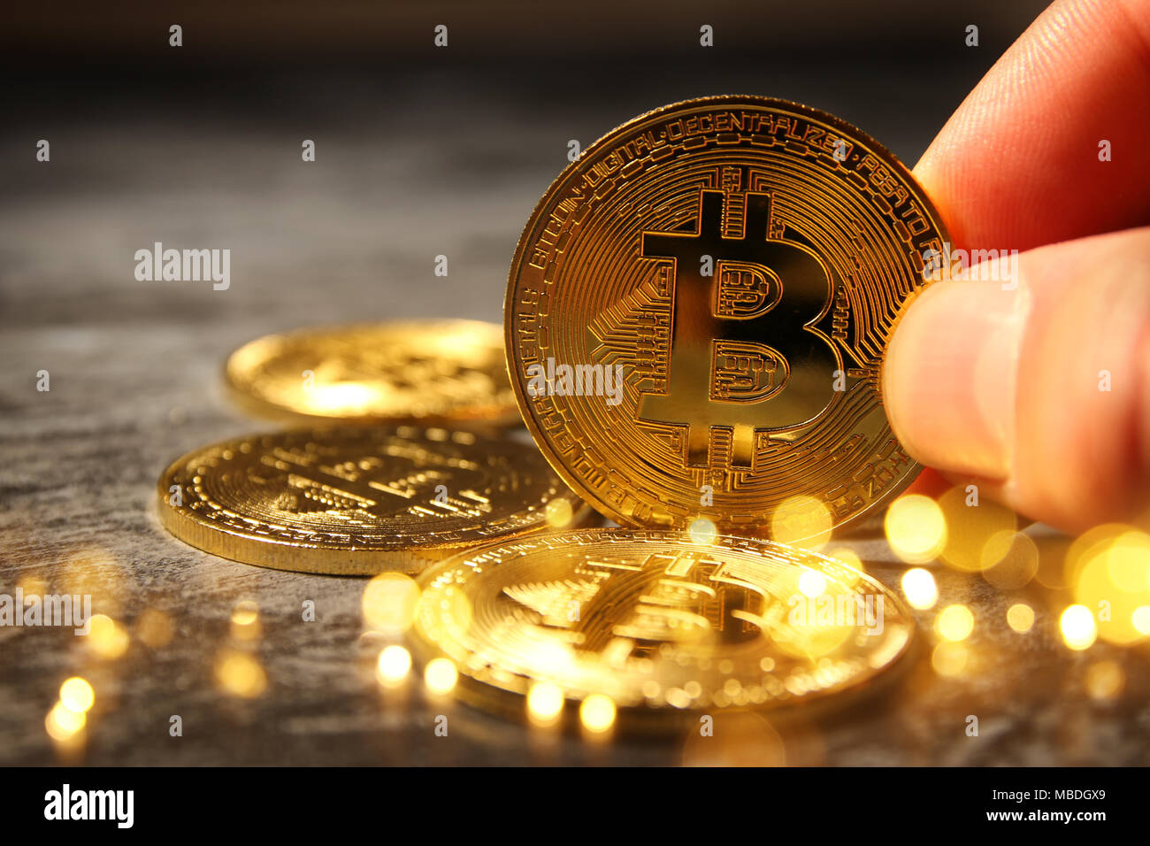 Man holding Golden Bitcoin over black background. Business concept ...