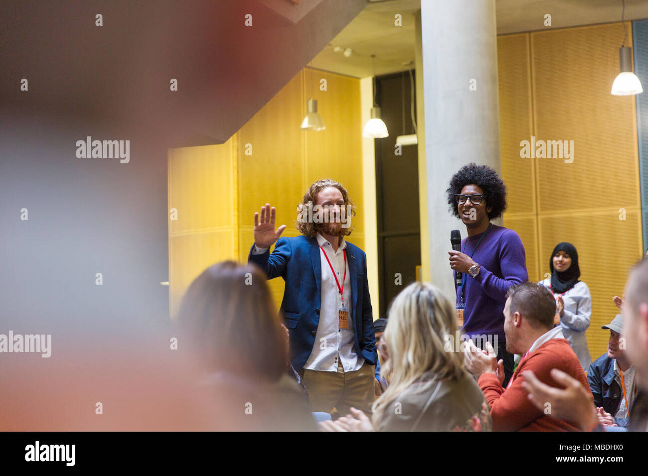 Conference audience clapping for male speakers Stock Photo - Alamy
