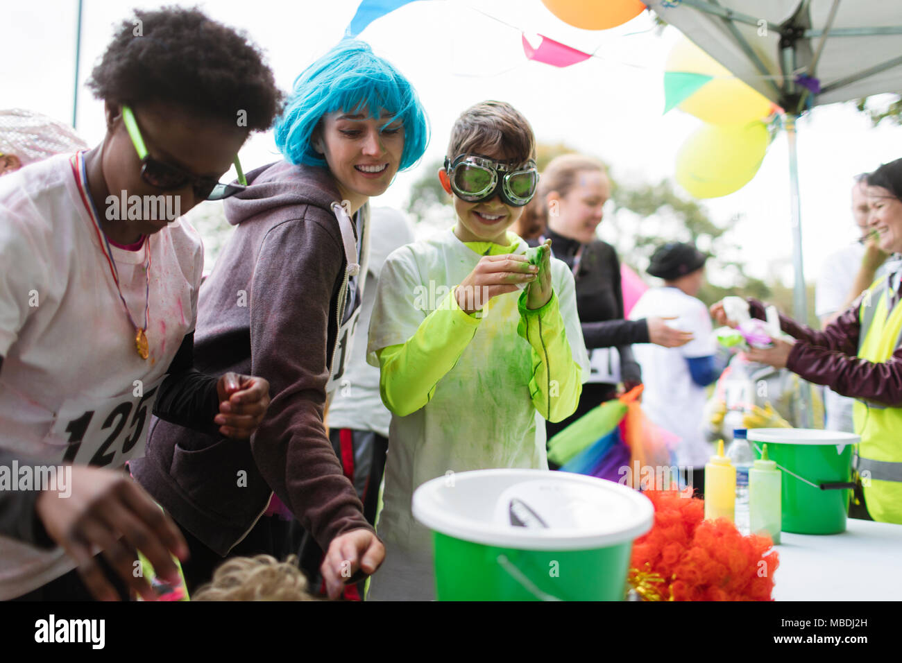 Runners with wig and holi powder at charity run tent Stock Photo - Alamy